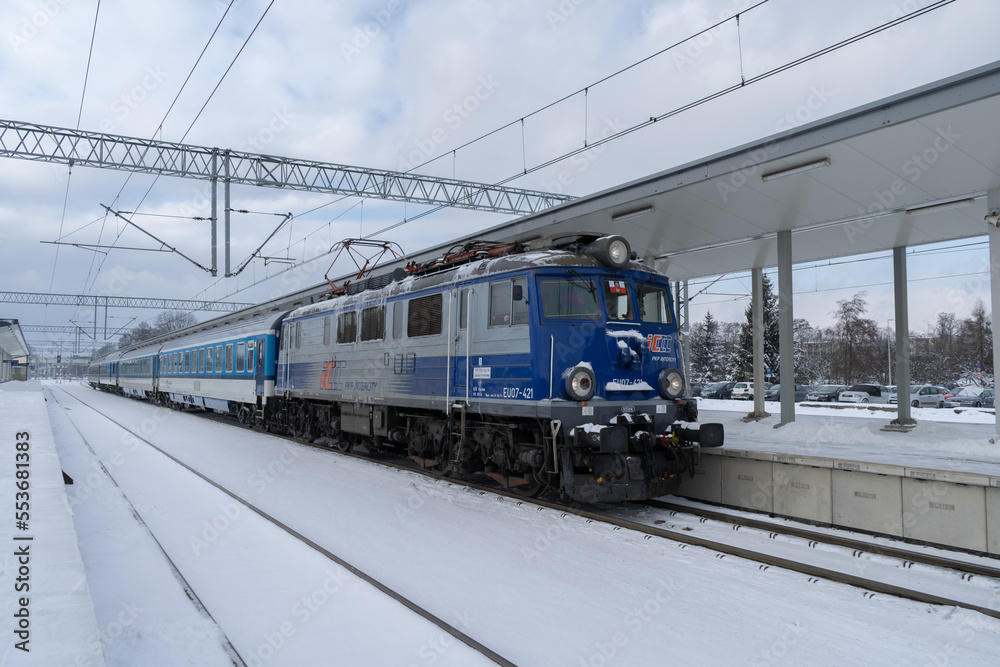 PKP Intercity EU07 electric locomotive with passenger cars. Long-distance express train at ...