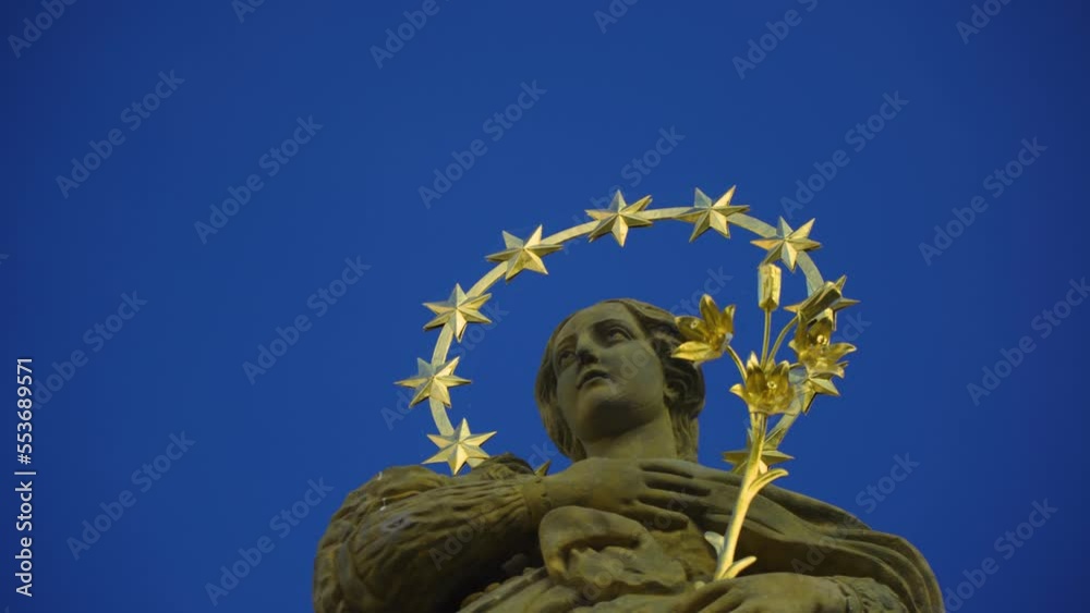 close up of beautiful proud statue that has golden plated halo around ...