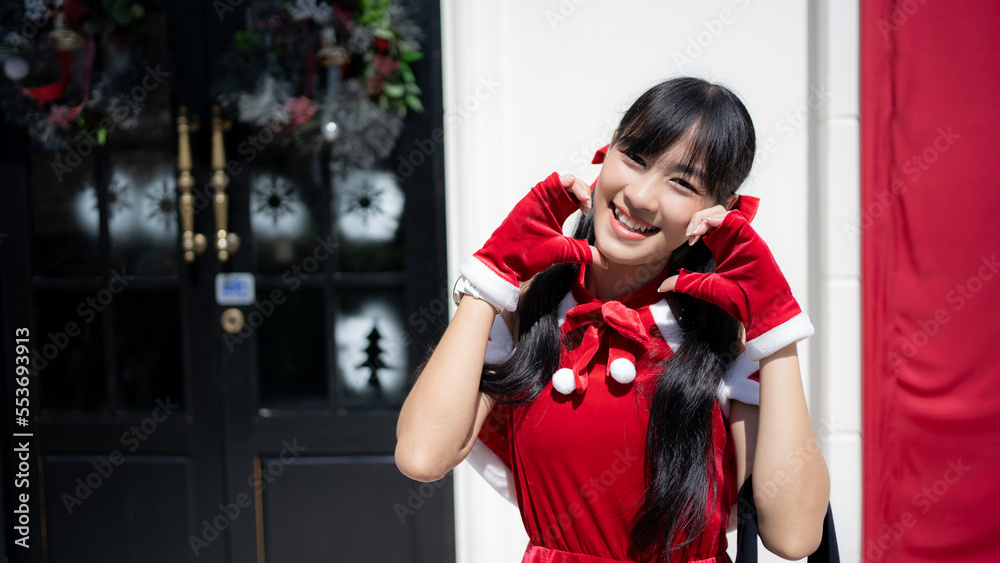 Asian women wear red Santa clause outfit costumes in standing poses ...