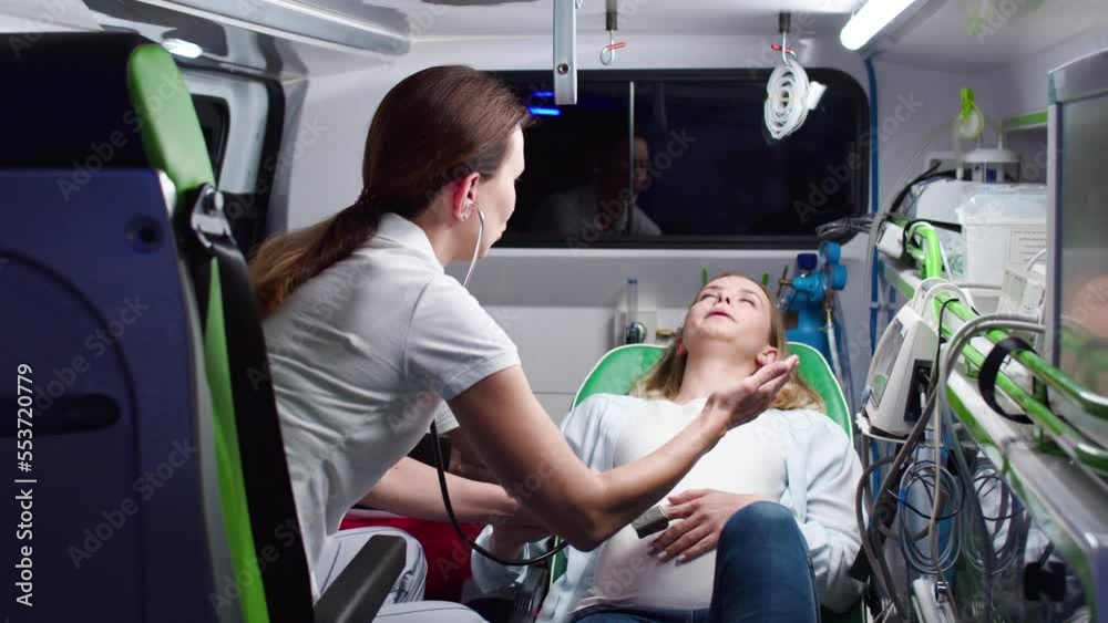 Professional multiethnic paramedics providing help measuring heartbeat ...