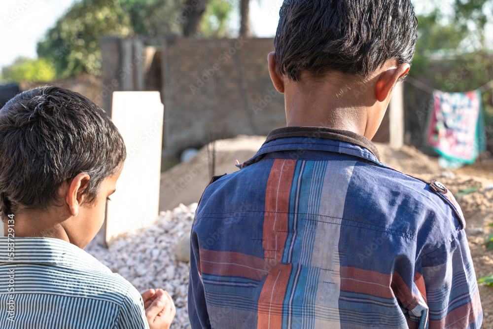 sad orphan children praying at their mother's grave Stock-Foto | Adobe ...