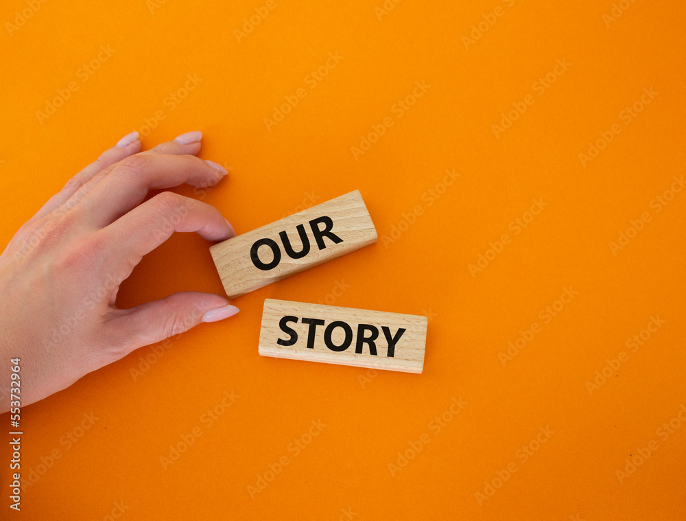 Our story symbol. Wooden blocks with words Our story Beautiful orange ...