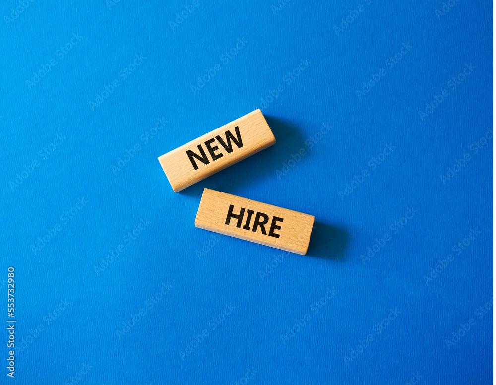 New hire symbol. Wooden blocks with words New hire. Beautiful blue ...