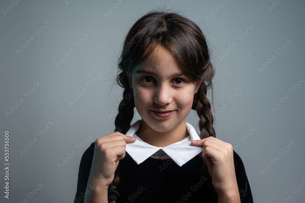 Portrait of little girl with Wednesday Addams costume during Halloween ...