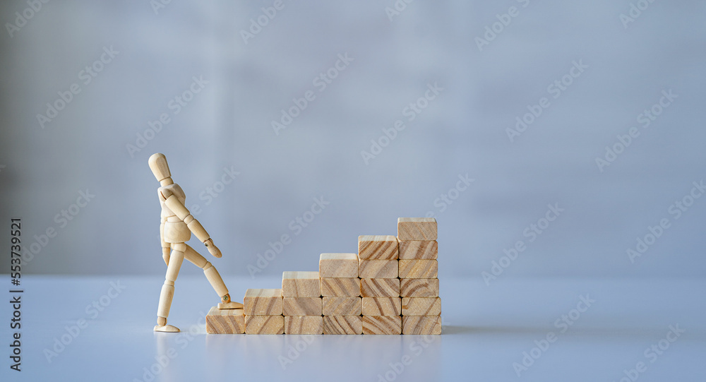 wooden man walking up the career ladder Wooden brick ladder, concept of ...