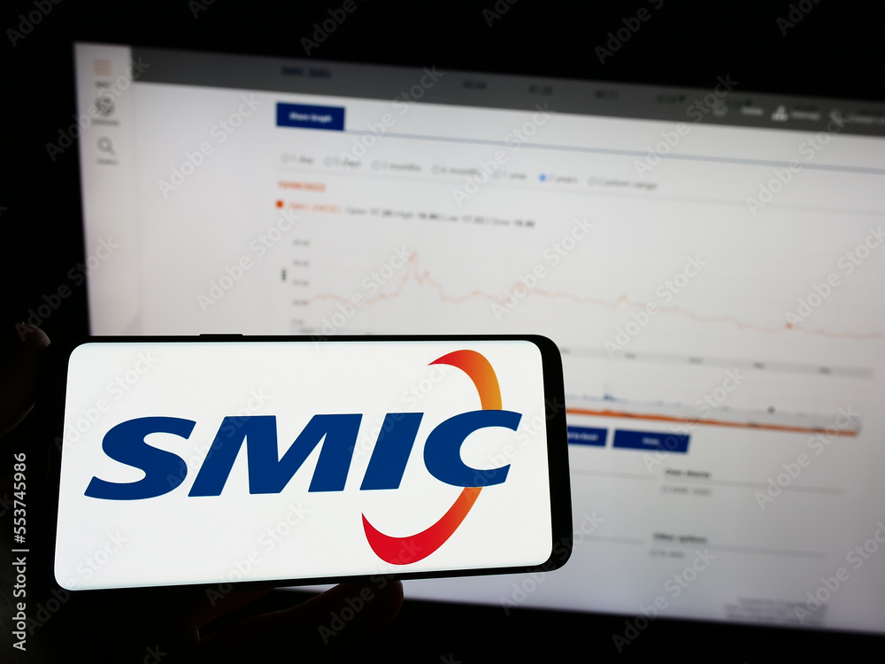 Stuttgart, Germany - 11-30-2022: Person holding phone with logo of Semiconductor Manufacturing ...