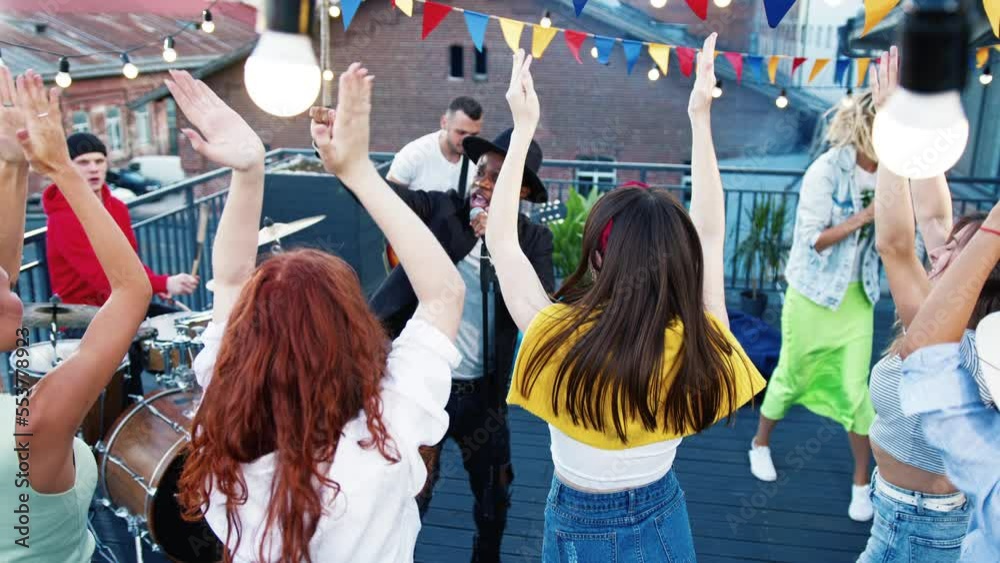 Young energetic African man rapper singing song with music band playing ...