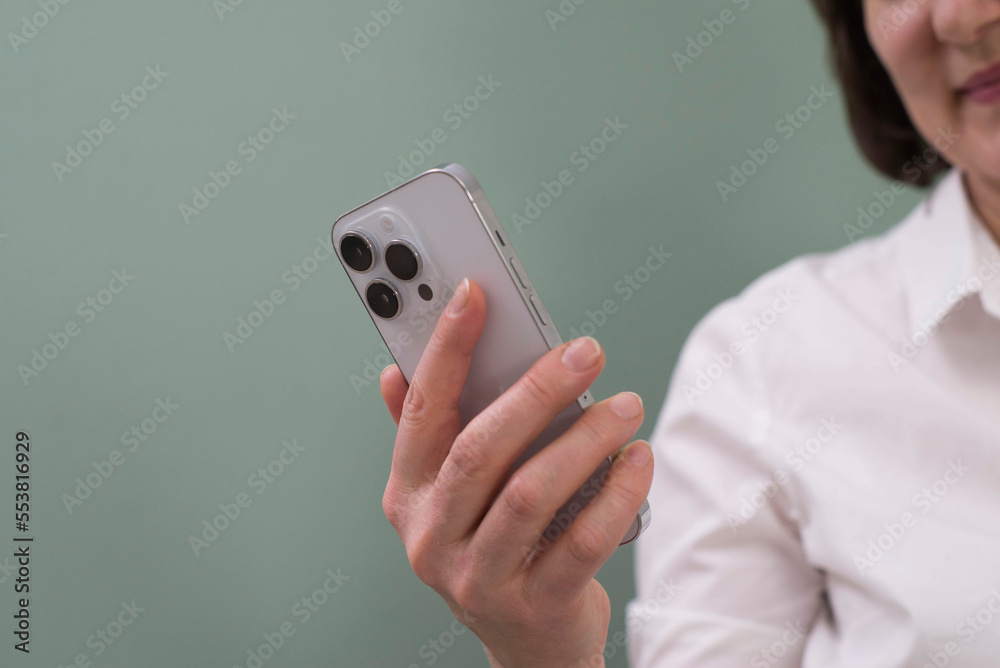 woman hand is holding Apple iPhone 14 Pro Max with isolated green ...