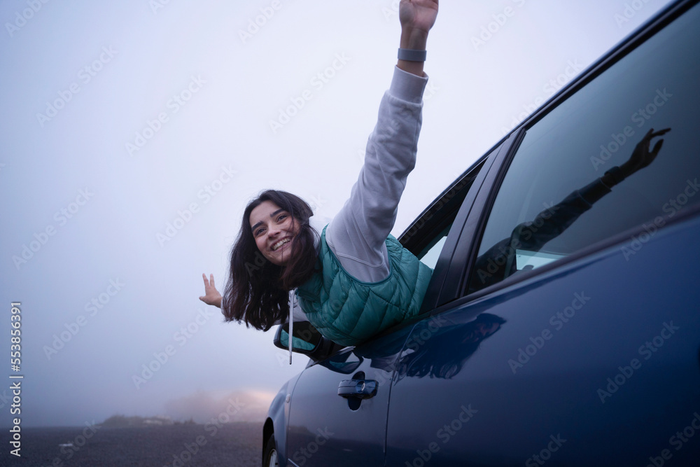 Side view of smiley woman driving the car for on a road trip Stock ...