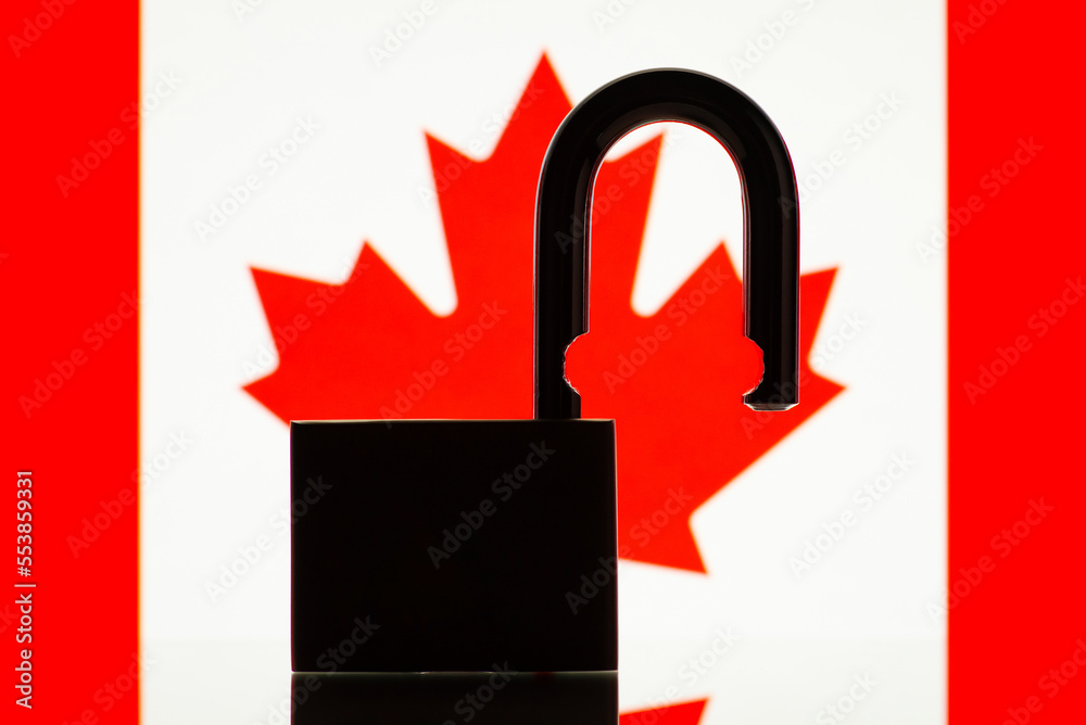 Black silhouette of open lock against flag of Canada. Reopen Canada ...