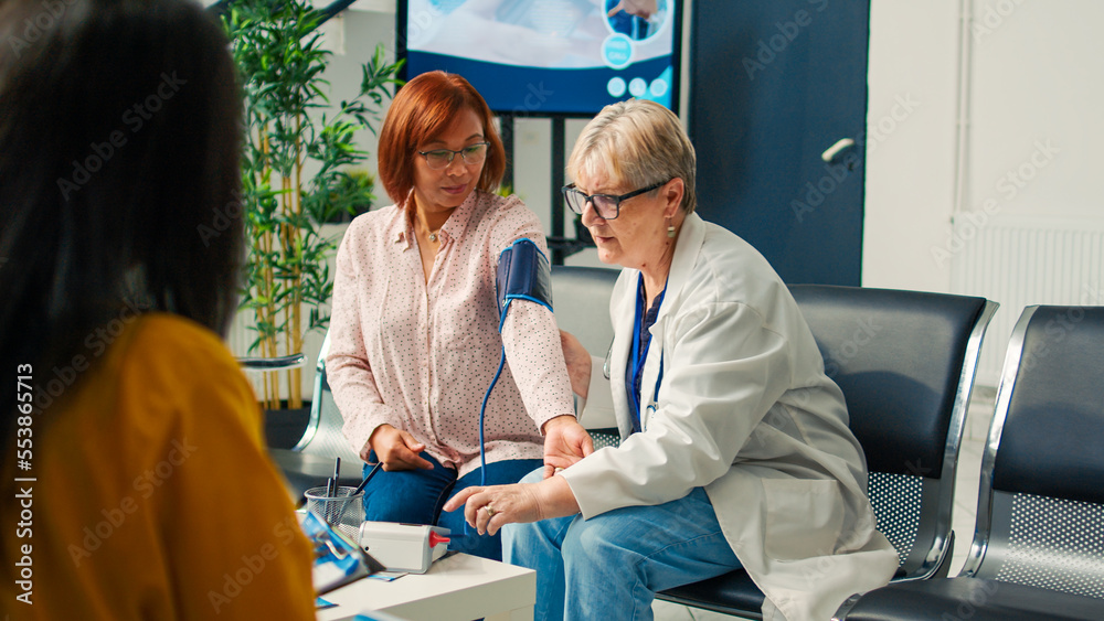 Physician checking blood and pulse pressure with tonometer, doing ...