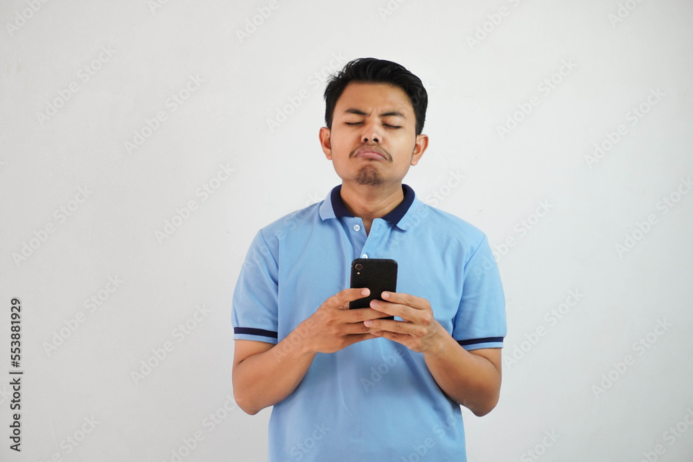 sad face with holding phone young asian man wearing blue polo t shirt ...