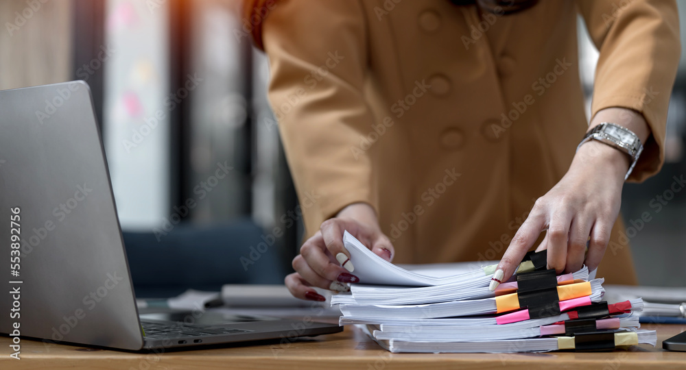 Businesswoman hands working in Stacks of paper files for searching and ...