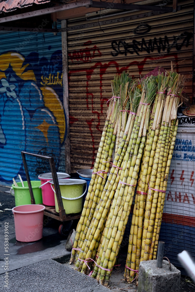 Sugar canes leaning on a wall in front of Petaling walking street in ...
