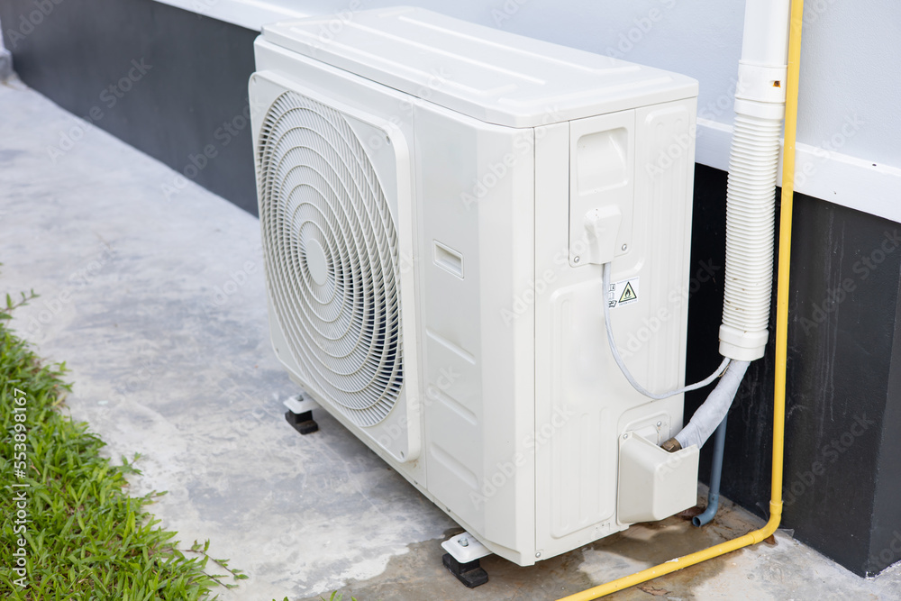 Side view of an air conditioner cooler installed on the exterior floor ...