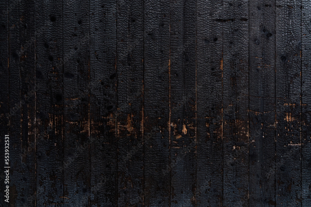 Burnt wooden plank surface after a fire. Details with patterned wood ...