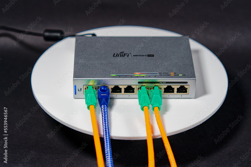 Unifi eight port gigabit switch with 4 Power over Ethernet PoE ports with plugged in ethernet ...