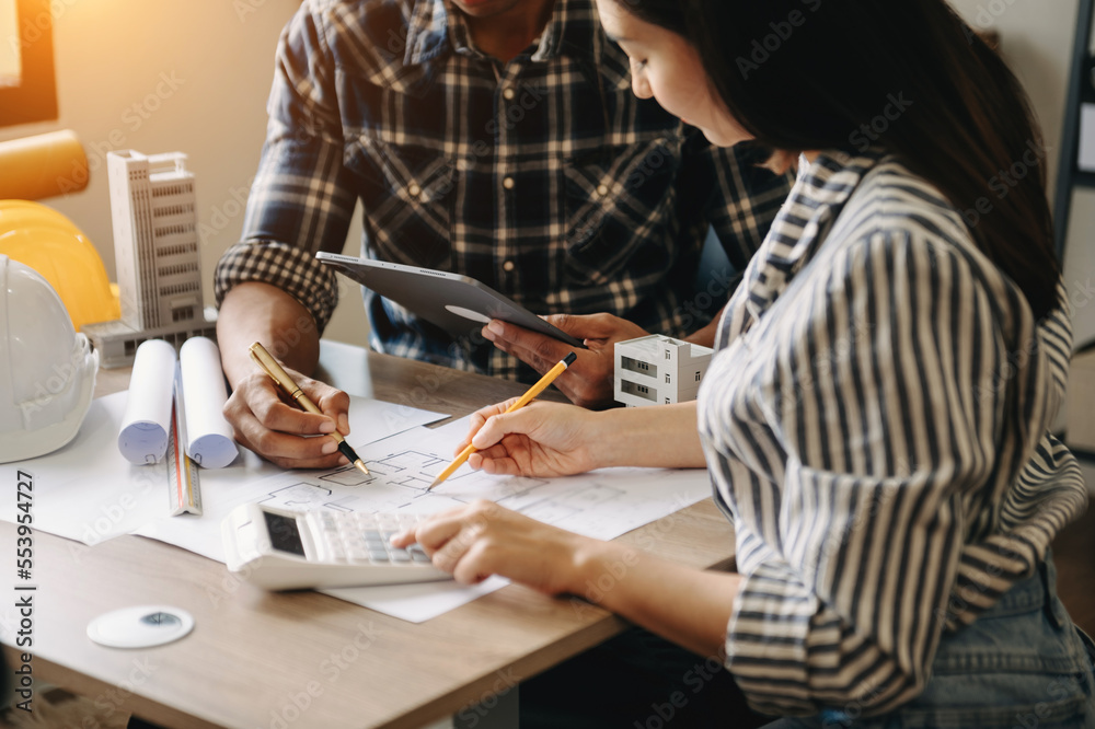Two colleagues discussing data working and tablet, laptop with on on ...