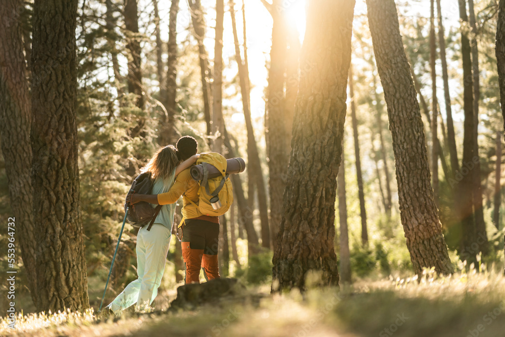 happy multiracial couple explorers through the forest - diverse couple ...