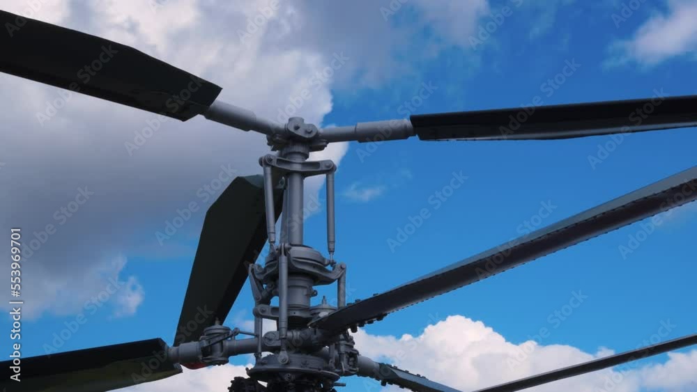 Stationary coaxial rotor of helicopter and blue, cloudy sky. A pair of ...