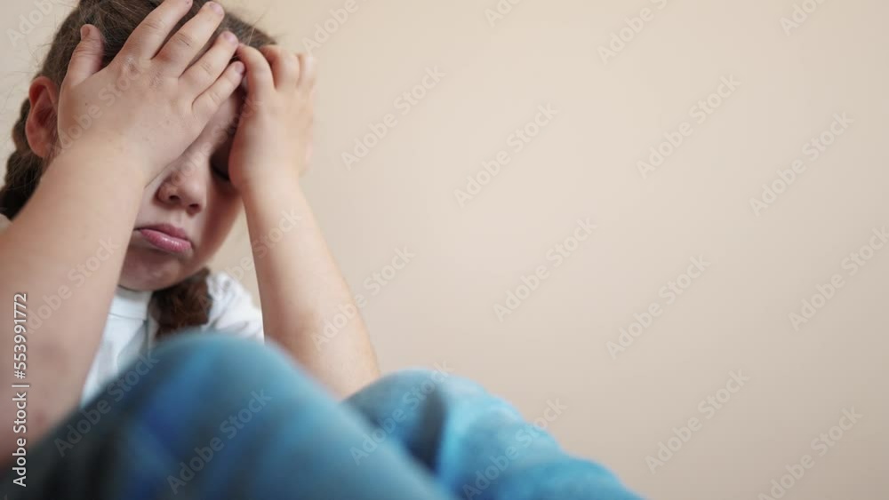 sad girl sitting in the corner crying a covered her face with her hands ...