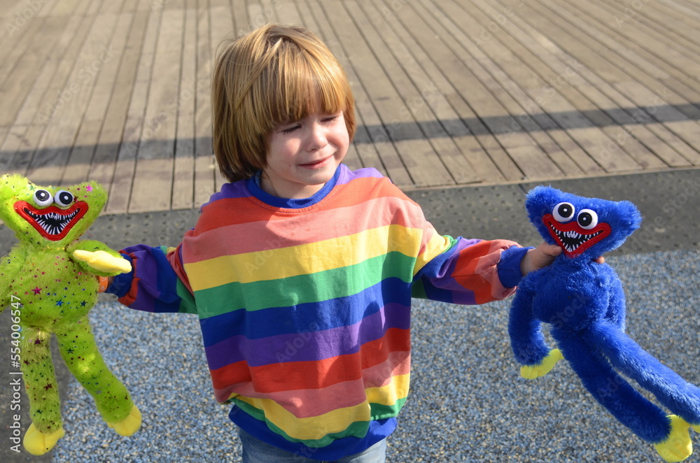 Little boy hysterical. Child whim. Soft toys Huggy Wuggy, violent ...
