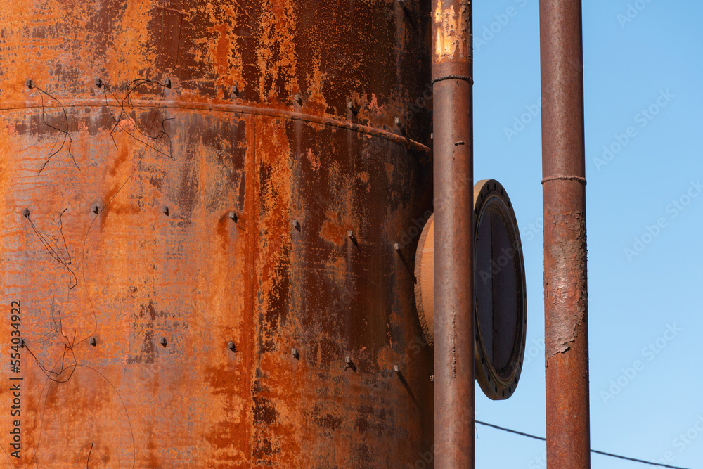 An old metal rusty water tower. Old production technology, processing ...
