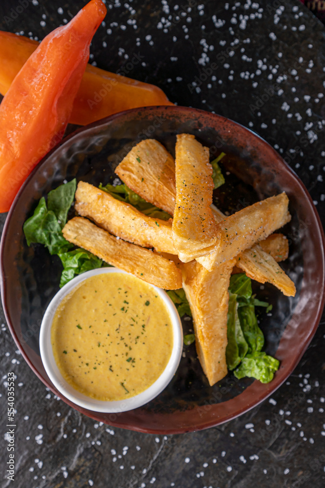 Yuquitas fritas, Peruvian yuca fries with dipping sauce. Stock Photo ...