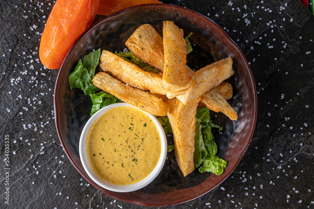 Yuquitas fritas, Peruvian yuca fries with dipping sauce. Stock Photo ...