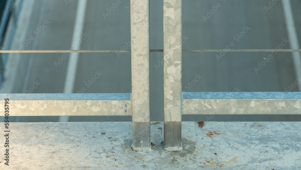 Modern metal fence made of metal profiles and cables. Connection and ...