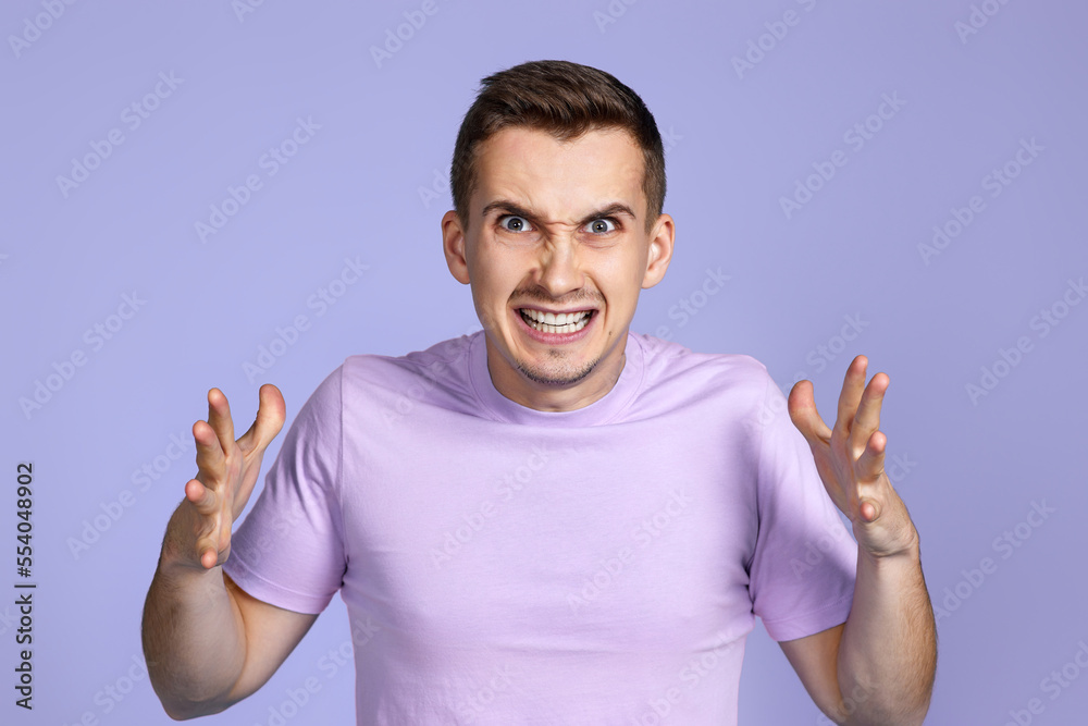 annoyed angry man on pastel purple studio background Stock Photo ...