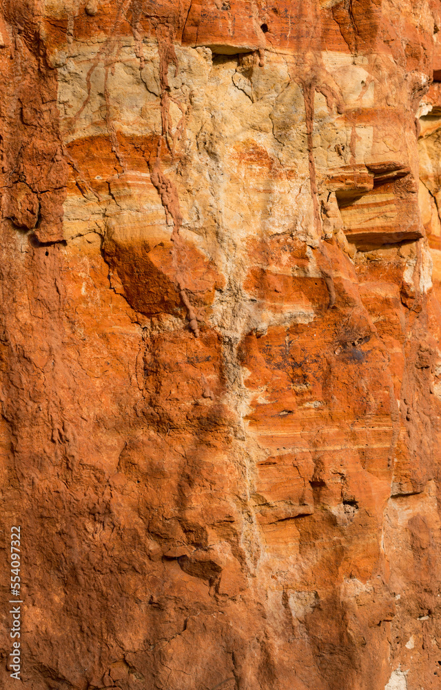 Sedimentary rocks with a high content of iron oxide. Red soil, loam ...