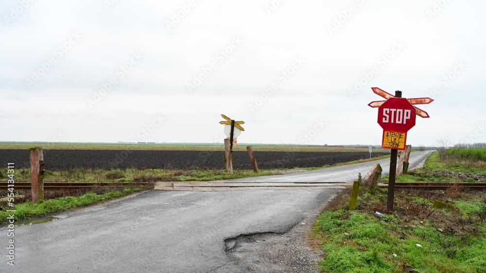 Railway crossing in the field. Crossbuck with stop sign. Warning sign ...
