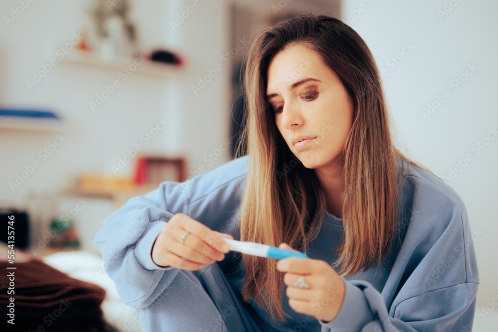 Woman Checking the Results of a Pregnancy Test at Home. Lady getting ...