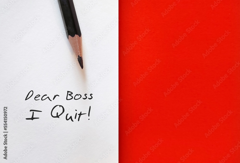 Pencil on white paper with handwritten text DEAR BOSS I QUIT, on red ...