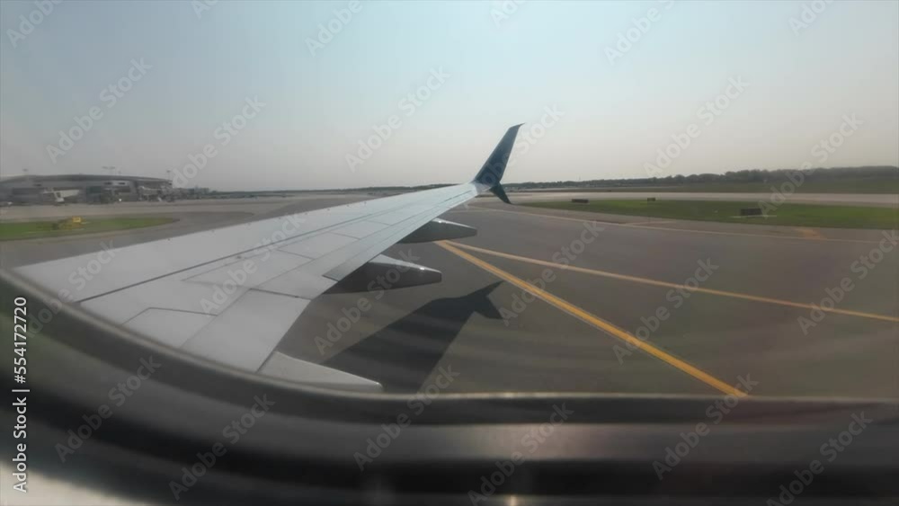 A plane landing on the tarmac view through the passenger window seeing ...