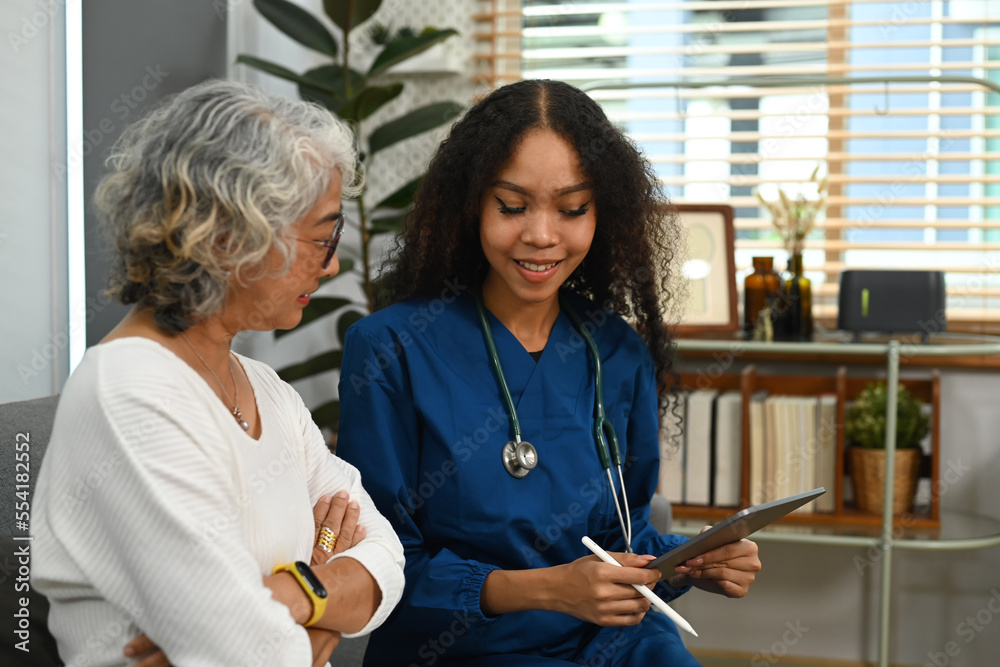 Doctor pointing at digital tablet screen, sharing health tests ...