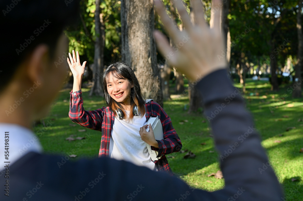 Two People Waving Goodbye