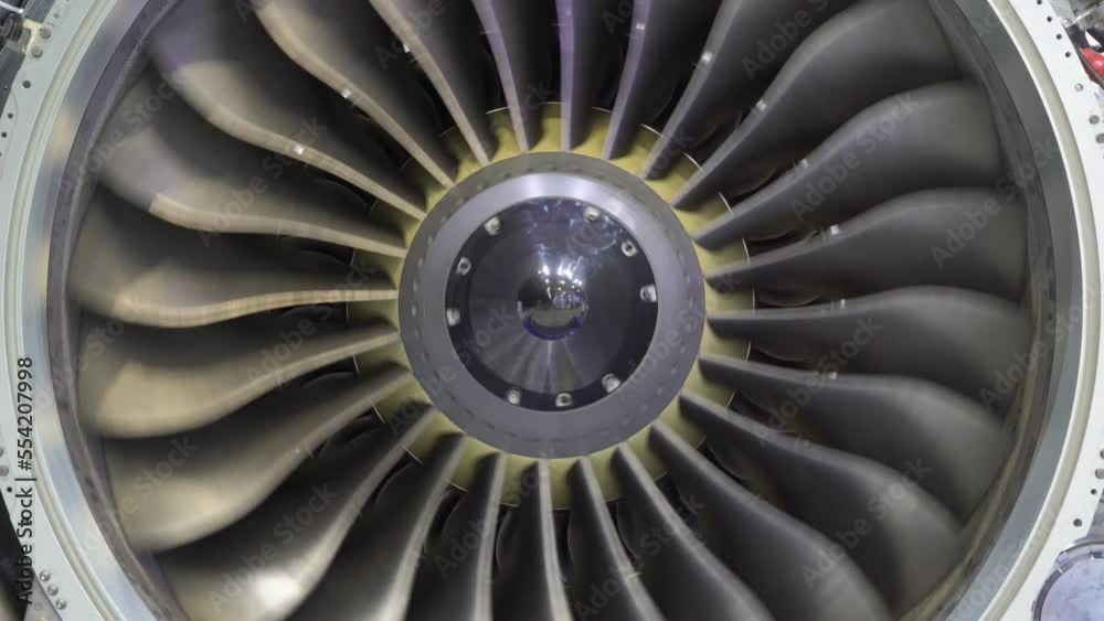 A close-up view of an aircraft jet engine turbine. Rotating turbine ...