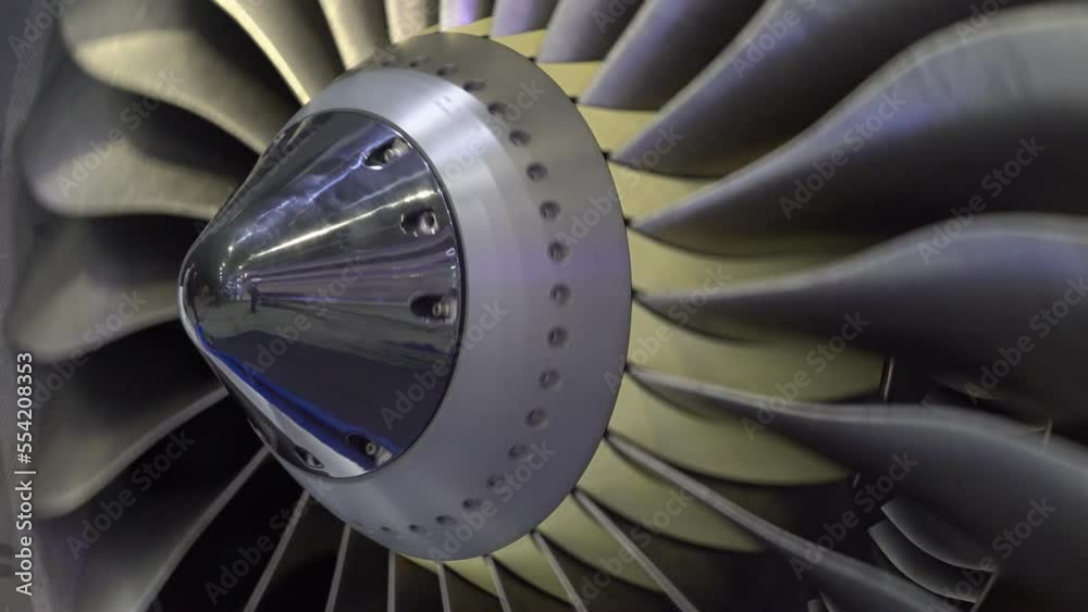 A close-up view of an aircraft jet engine turbine. Rotating turbine ...