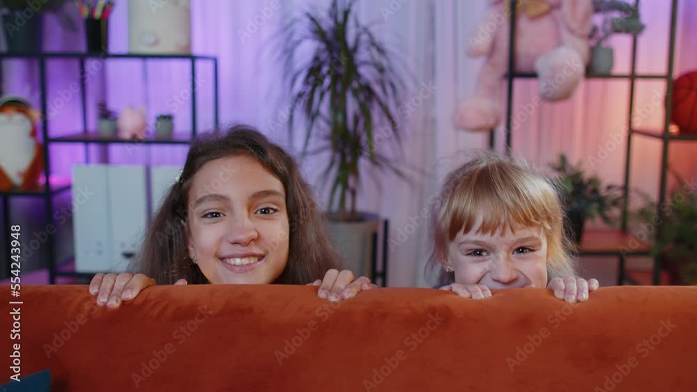 Teenage child and little sister kid girls playing hide and seek ...
