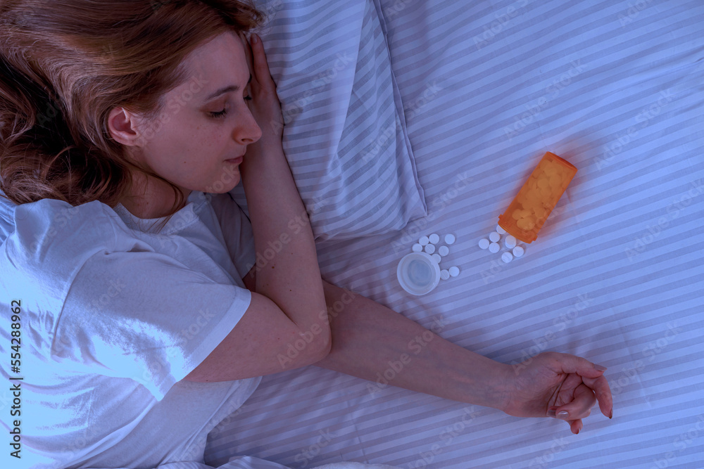 Sleeping pills, medicine. Woman sleeping in bed at home. Effects of ...