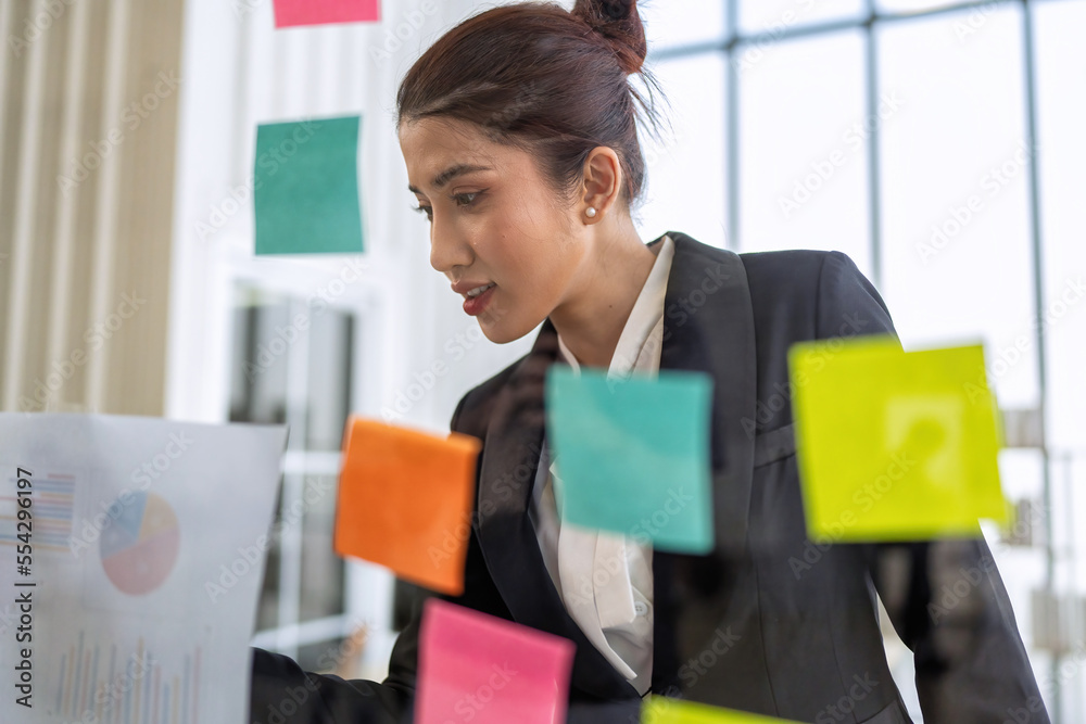 Employee meeting at office and use post it notes to share idea ...