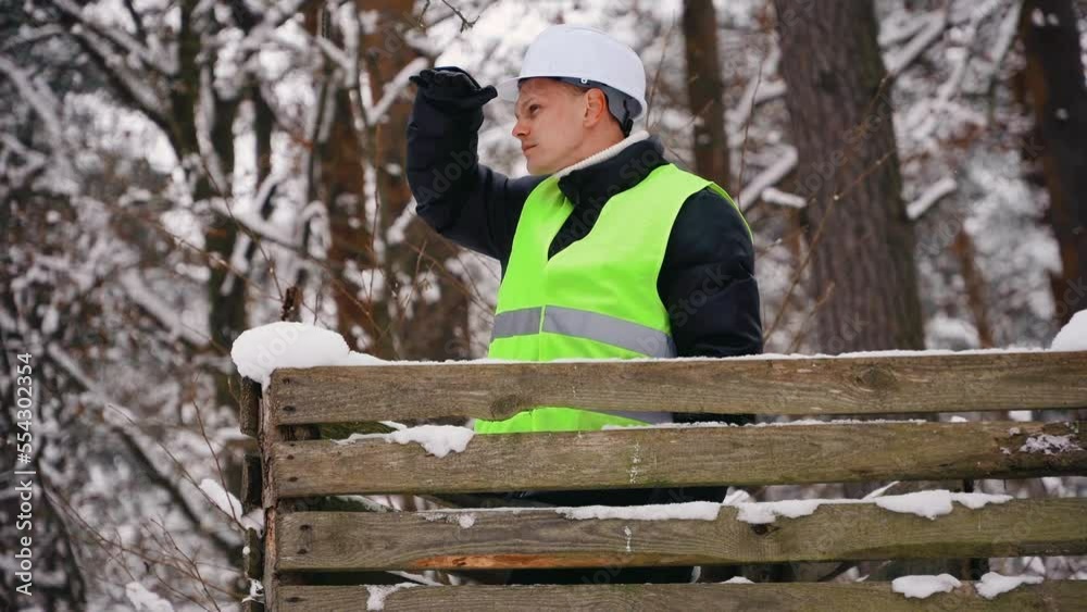 Video Stock Portrait forester in safety helmet and protective vest is ...
