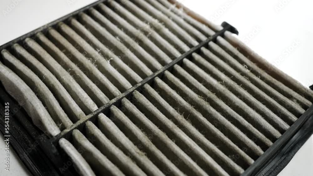 very dirty and dusty air filter element on a white background rotation ...