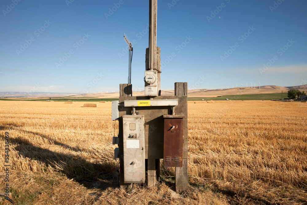 An electrical power meter and distribution panel box in the middle of a ...