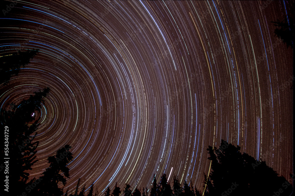 Long exposure of stars creating star track patterns in the night sky ...