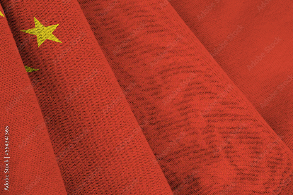 China flag with big folds waving close up under the studio light ...
