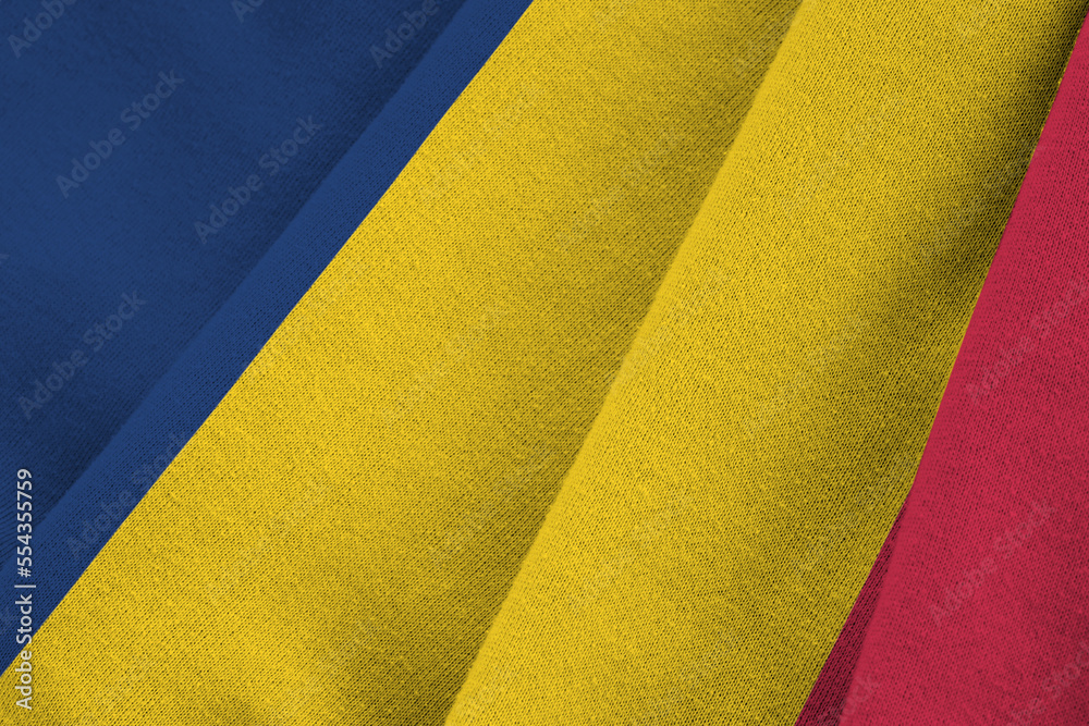 Chad flag with big folds waving close up under the studio light indoors ...