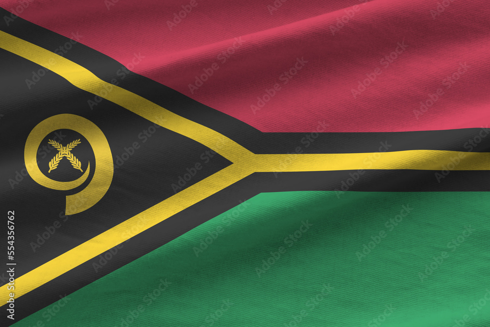 Vanuatu flag with big folds waving close up under the studio light ...